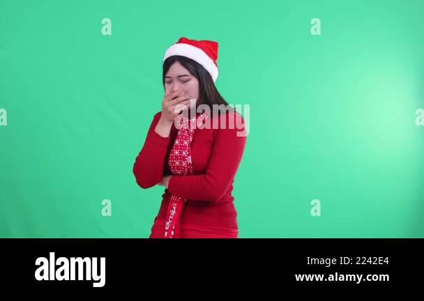 Asian girl wearing Christmas sweater, Santa hat and scarf, showing ...