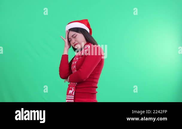 expression of young asian woman wearing christmas sweater, santa hat ...