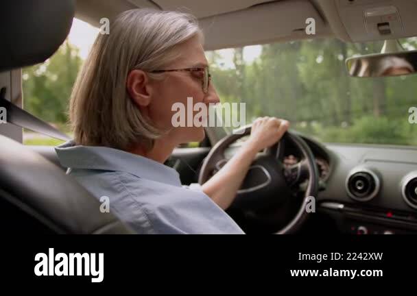 Displeased confused Caucasian aged woman senior female taxi driver ...
