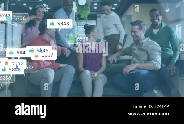 Socializing indoors, diverse group receiving social media notifications ...