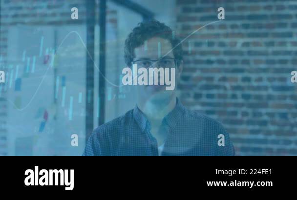 Financial data charts and graphs animation over smiling man in office ...