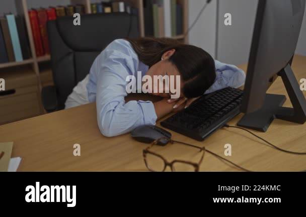 Woman sleeping at computer desk in office awakens to male colleague ...