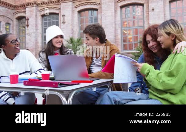 Group of Diverse Students Collaborating on a Laptop in an Outdoor Study ...