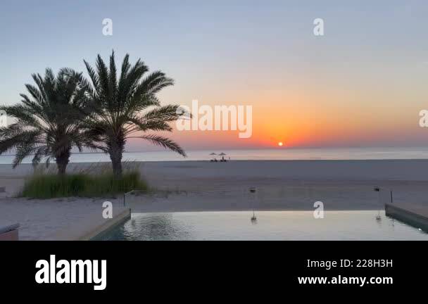 Morning reflection bliss as sunrise mirrors in infinity pool and sea ...
