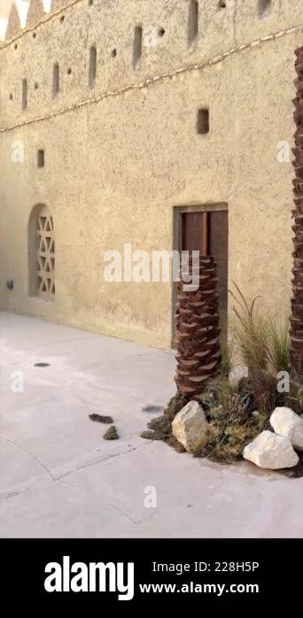 Vertical screen:Desert fort reconstructed with sandstone walls ...