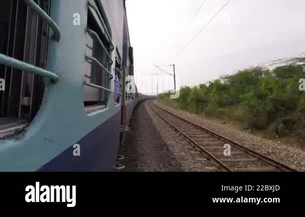 POV or first hand view of a train in india. Camera out of the train ...