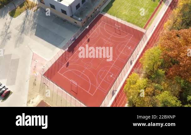 Red outdoor court with running track Stock Video Footage - Alamy