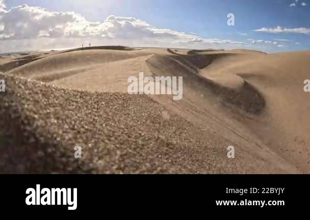Witness the mesmerizing movement of sand being carried by the wind in ...