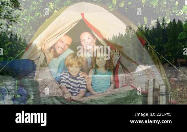 Family camping in tent over forest and river landscape. outdoors ...