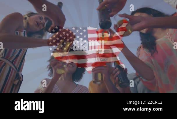 Group of friends toasting with drinks over USA flag animation ...