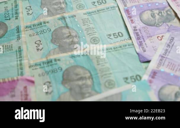 Indian rupee banknotes spread out showcasing currency details and ...