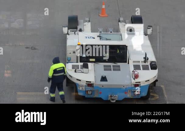Airport Ground Crew Coordinating with Pushback Tractor for Airplane ...
