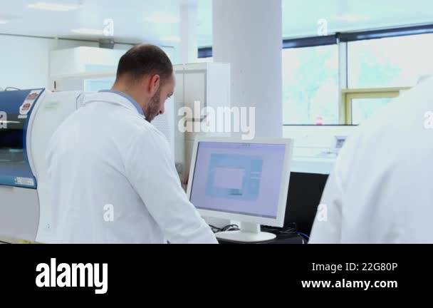 Professional scientist wearing white lab coat analyzing complex data on ...