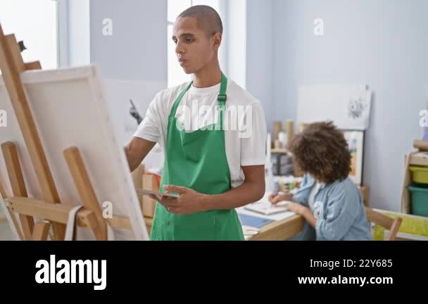 Young man and beautiful woman artists immersed in a serious drawing ...