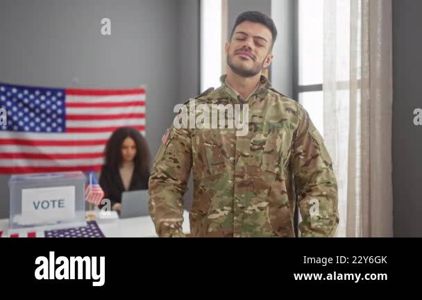 A man in military uniform holding a 'i vote for change' sign with a ...