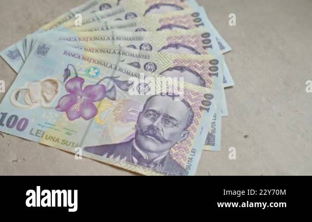 Romanian leu banknotes arranged on a concrete surface, highlighting ...