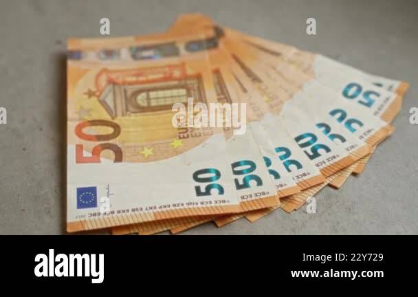 Euro banknotes fanned out on a concrete surface illustrate european ...