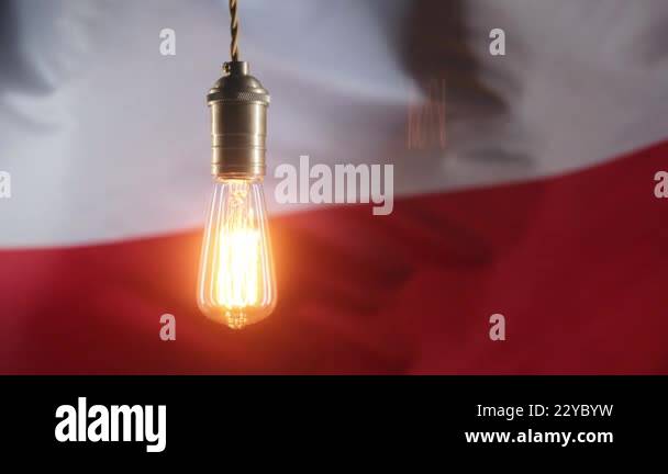 Flashing Edison light bulb on polish flag background. Bad electricity ...