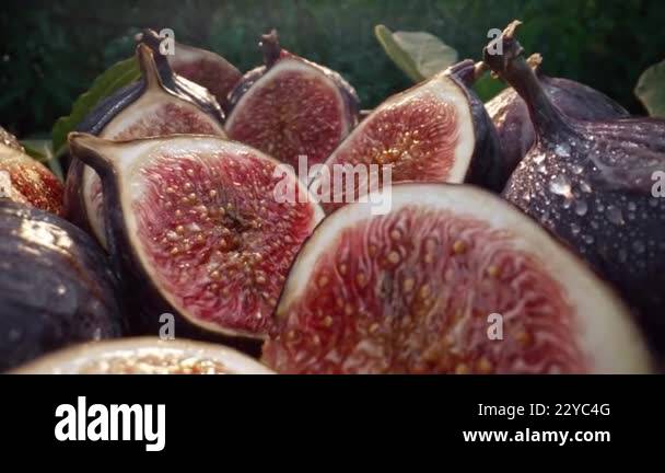 Camera moves between sliced halves, healthy juicy ripe figs. Dolly ...
