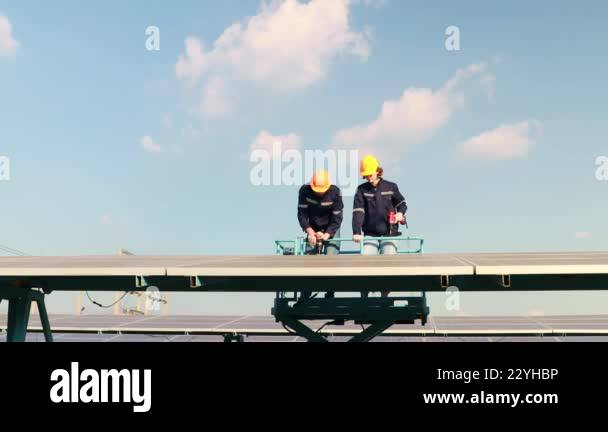 Repair team leads male and female technicians onto lifts inspects solar ...