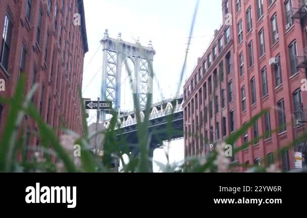 New York City Manhattan Bridge in Dumbo, Brooklyn. Red brick building on Washington street near ...