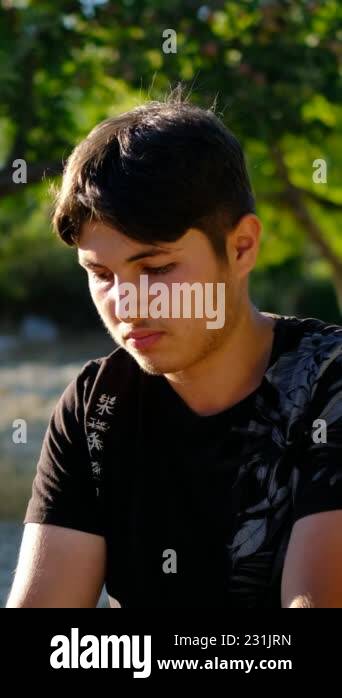 Young man worshiping outdoors, praying from Islamic rules on garden ...