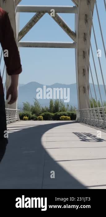 young man watching the view over the metal bridge, image of a person ...
