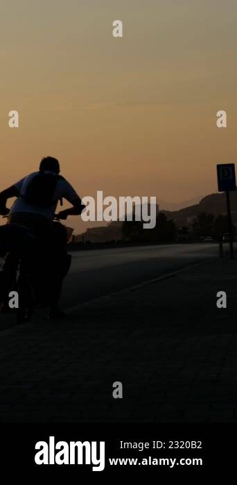 Man riding bike sunset videos, cycling at sunset, outdoor sports activities, black and yellow ...