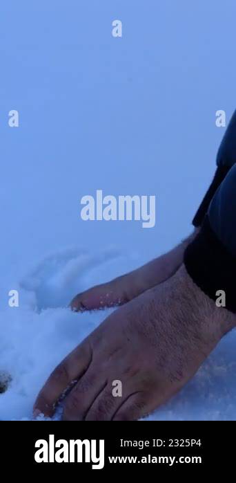 Making snowballs, rolling a handful of snow into a ball, making the ...