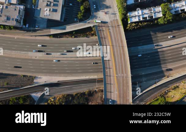 An aerial view reveals a busy highway with many cars creating a dynamic ...