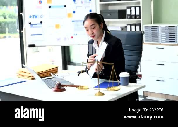 Professional female lawyer working on laptop computer during video chat ...