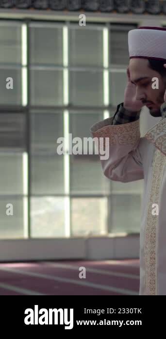 Standing mosque teacher starts prayer, different angle shot of young ...