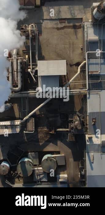 Paper production factory that throws fumes from its chimney, drone view ...