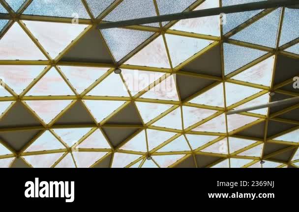 Modern geometric yellow lattice roof structure with a repetitive ...