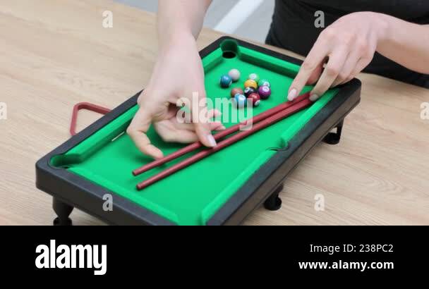 Installation of a mini-billiard with colorful balls and accessories ...