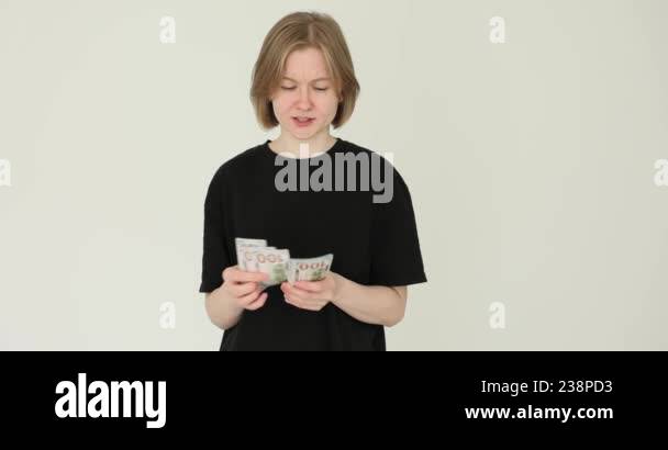 Young happy student counting money dollar on white background. Woman ...