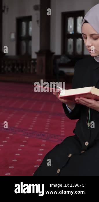 Woman in hijab reciting quran inside mosque, praying al-quran on ...