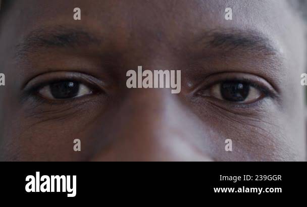 Close-up slow motion portrait of African American man looking at camera ...