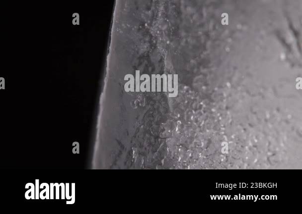 Melting ice viewed through a microscope, movement of ice and water in ...