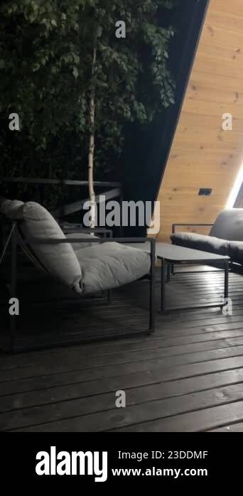 Modern outdoor seating area with gray cushioned furniture, a sleek ...