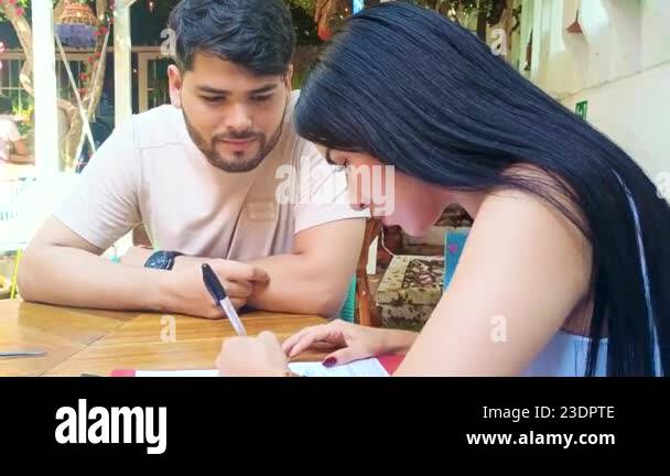 Two young Colombians signing a model release inside a coworking space in Neiva - Huila ...
