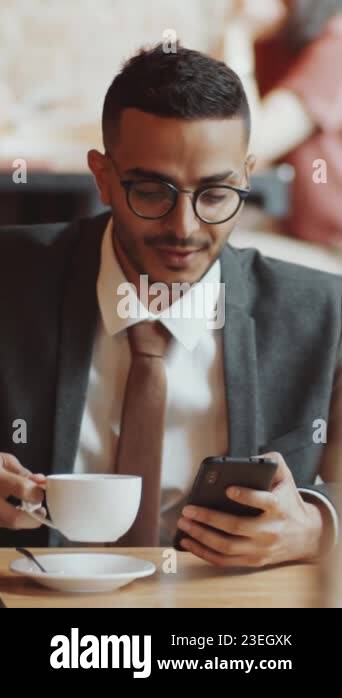 Vertical view of young male entrepreneur with glasses dressed formally ...