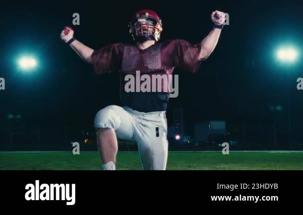 American football player celebrates victory in the stadium, raising ...