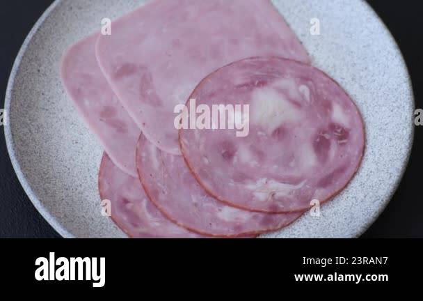 Boiled ham with salt and spices cut into slices on dark concrete ...