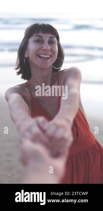 vertical shot. Valentine's Day. girl in a dress on the beach. happy ...