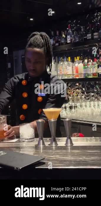 bar pouring alcoholic drinks bartender preparing cocktail looking at ...