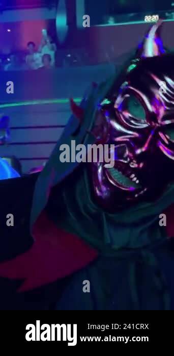 scary devil mask with horns man looking into frame dancing light music ...