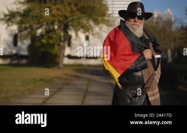 A senior man, identified as a traditional German farmer, confidently ...