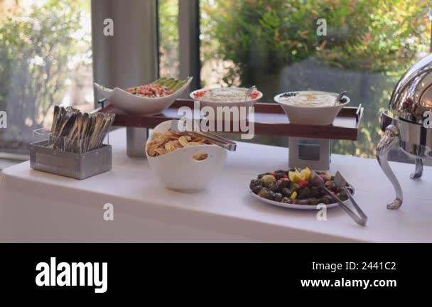 A sophisticated buffet setup featuring a variety of dishes on a raised ...