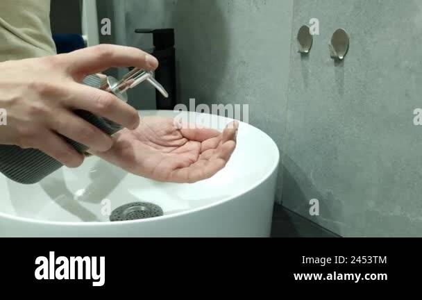 Person using dispenser to apply liquid soap, hygiene and sanitation ...